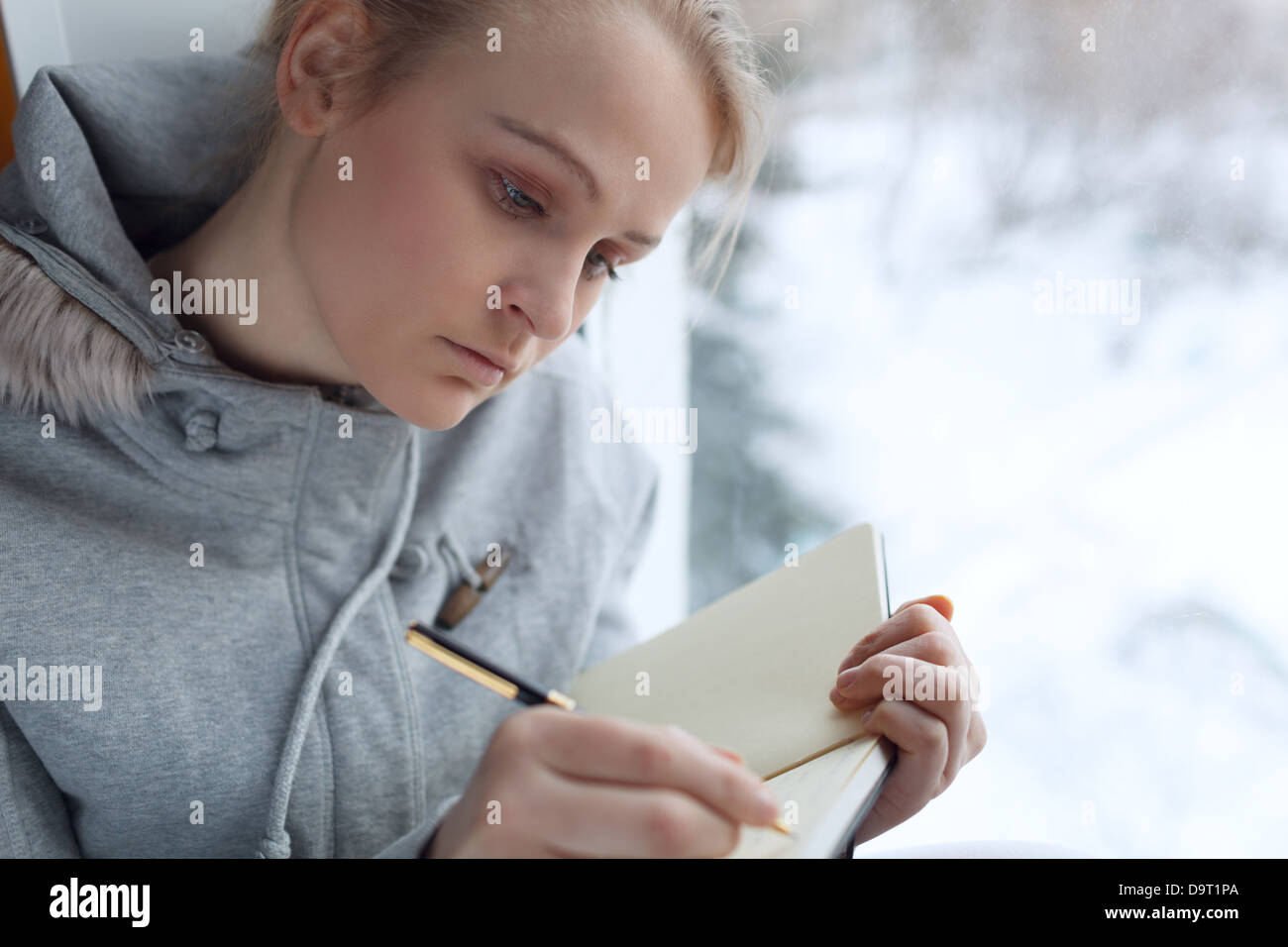 Young girl writing in her journal Stock Photo - Alamy
