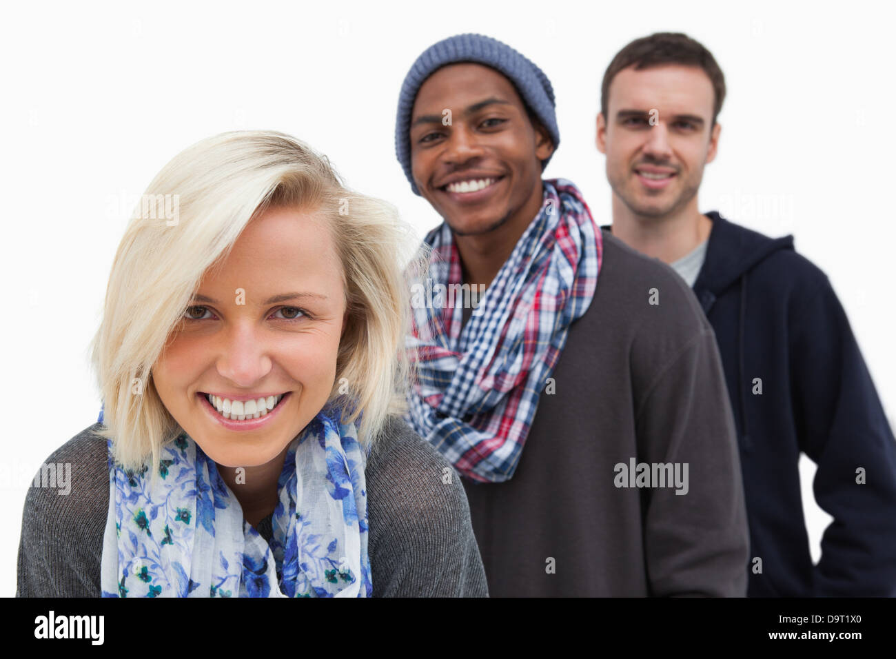 Three stylish friends looking at camera and smiling Stock Photo - Alamy