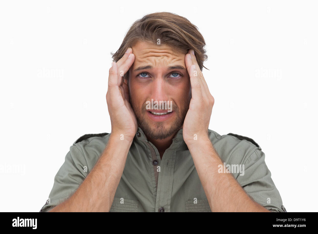 Man grimacing with pain of headache and looking up Stock Photo - Alamy