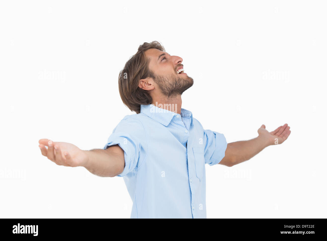 Happy man looking up with arms outstretched Stock Photo - Alamy