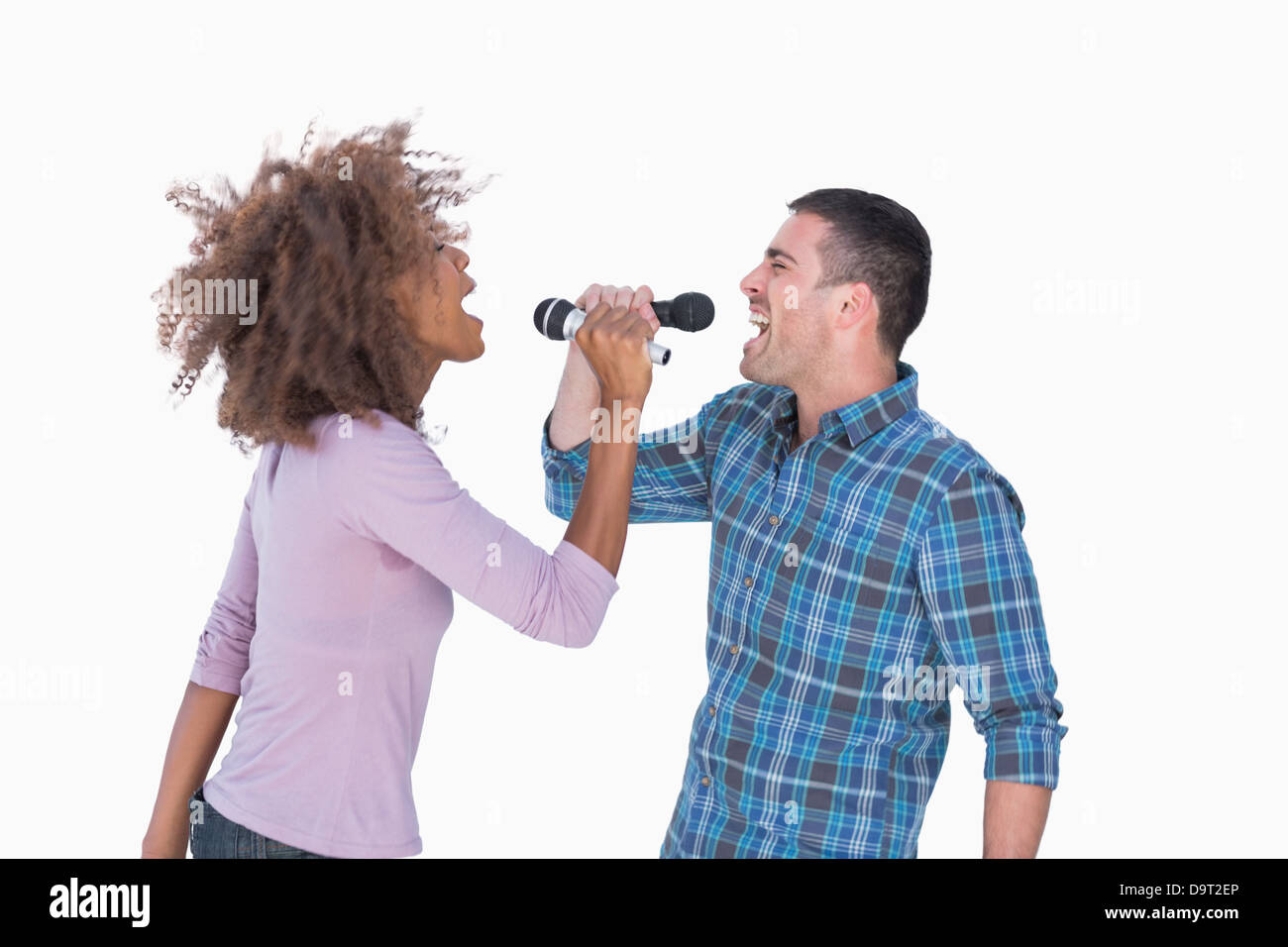 Fun duo singing to each other at karaoke Stock Photo - Alamy
