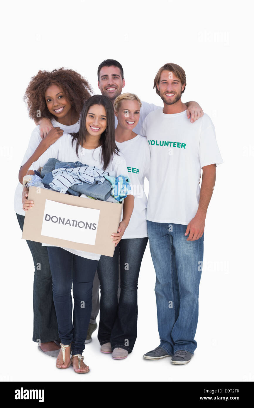 Happy group of volunteers holding donation box Stock Photo - Alamy
