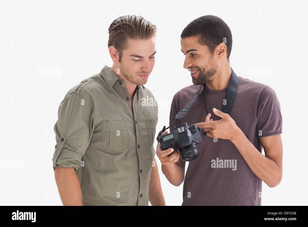 Photographer showing his friend photo on camera Stock Photo - Alamy