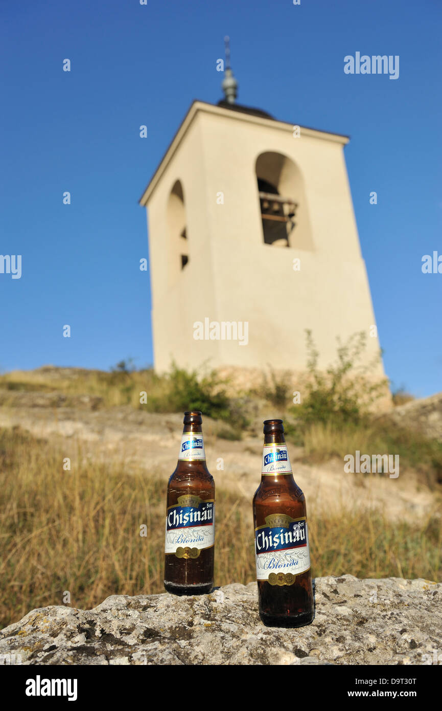 Two bottles of Chisinau beer beside bell tower at the entrance to a ...
