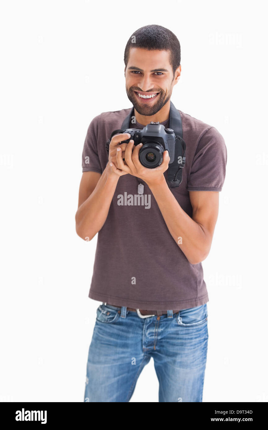Cheerful man with camera around his neck Stock Photo - Alamy