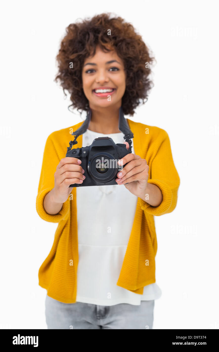 Pretty girl holding digital camera Stock Photo - Alamy