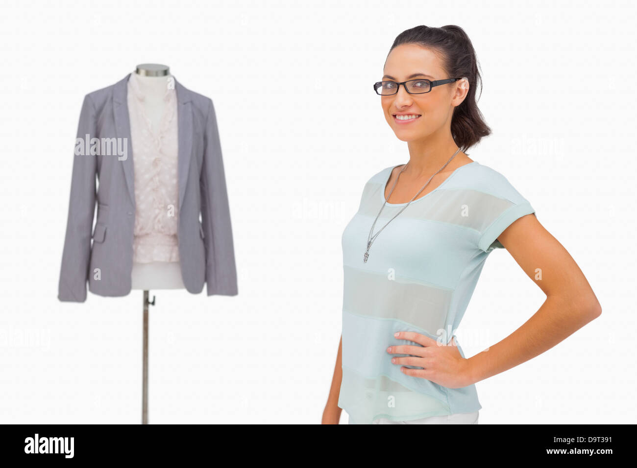 Designer smiling beside her mannequin Stock Photo - Alamy