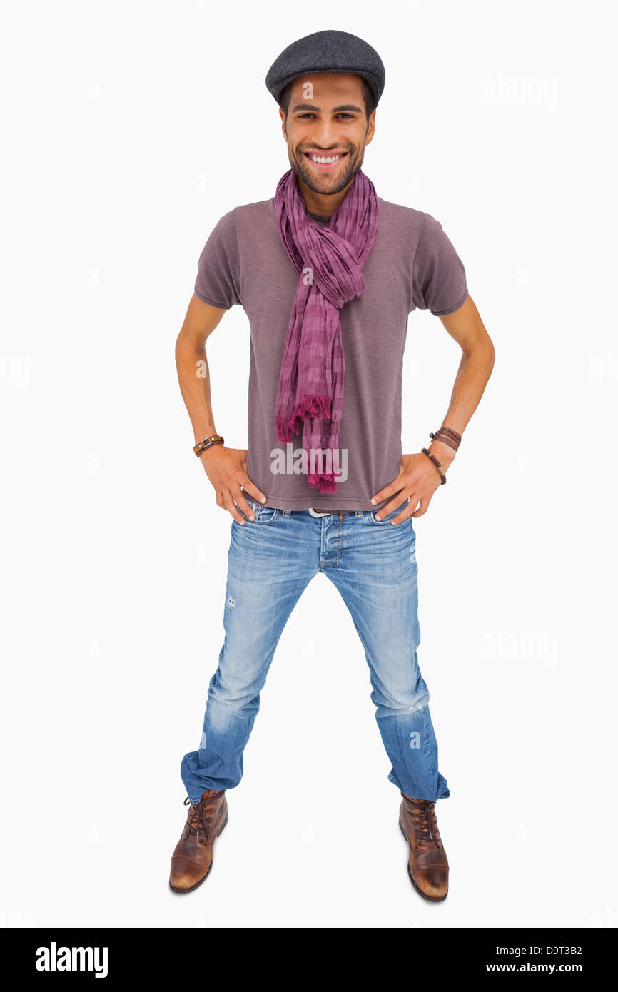 Happy man wearing peaked cap and scarf looking at camera Stock Photo ...