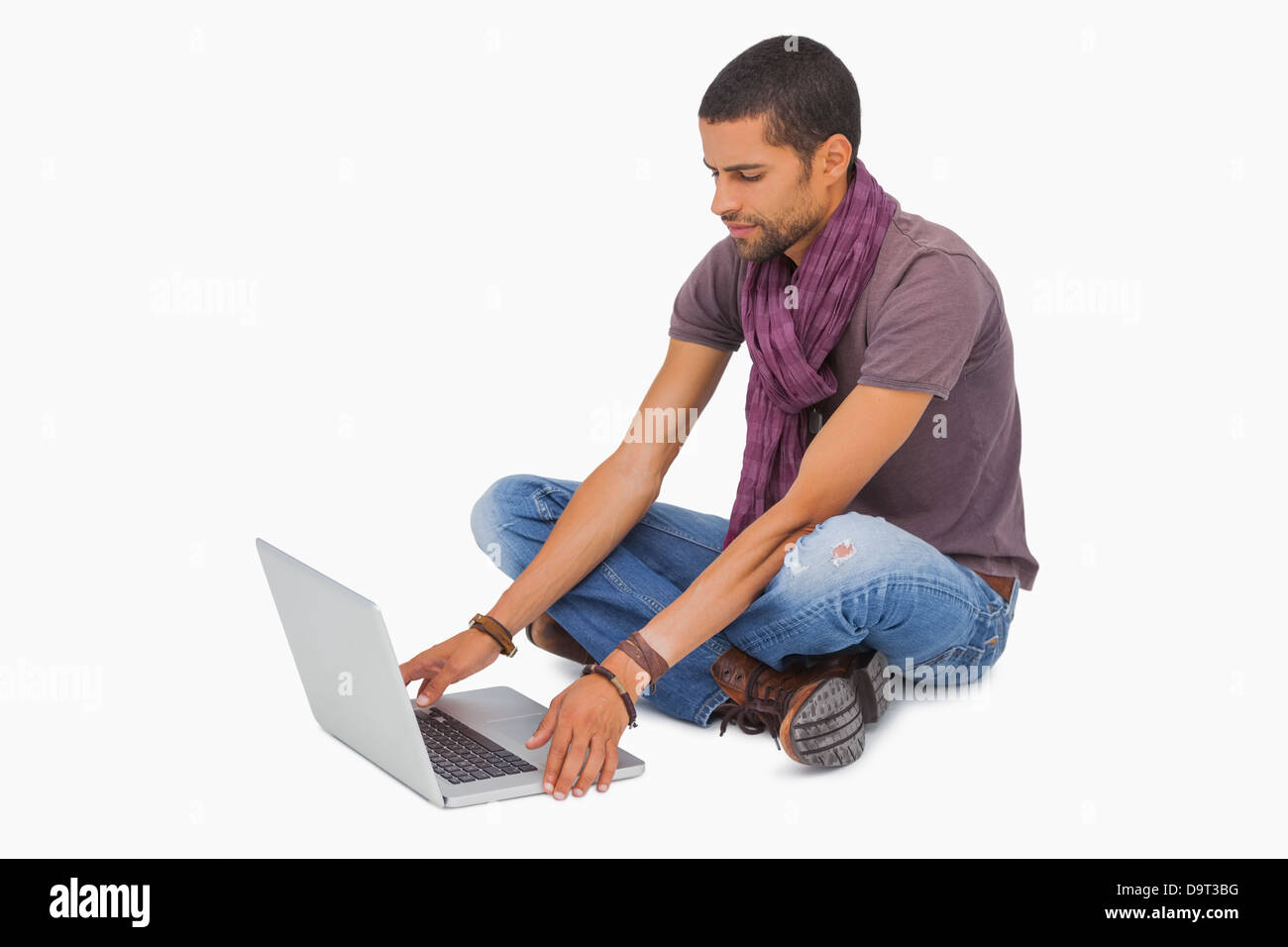 Man sitting on floor using laptop Stock Photo - Alamy