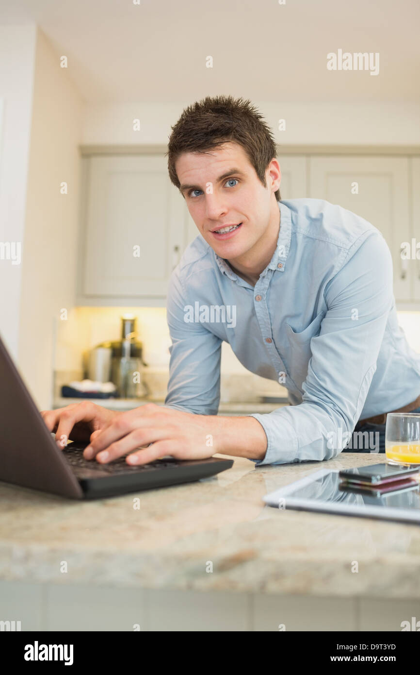 Man enjoying typing at the laptop Stock Photo - Alamy