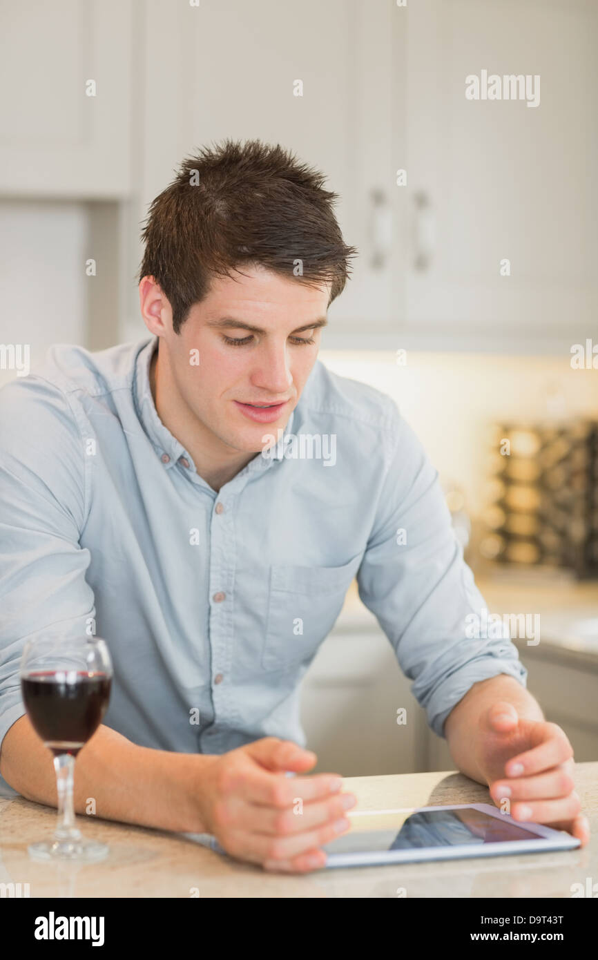 Man looking at his tablet pc Stock Photo - Alamy