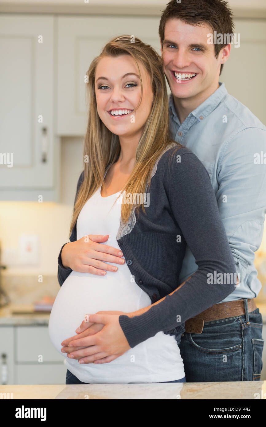 Man embracing pregnant partner Stock Photo - Alamy