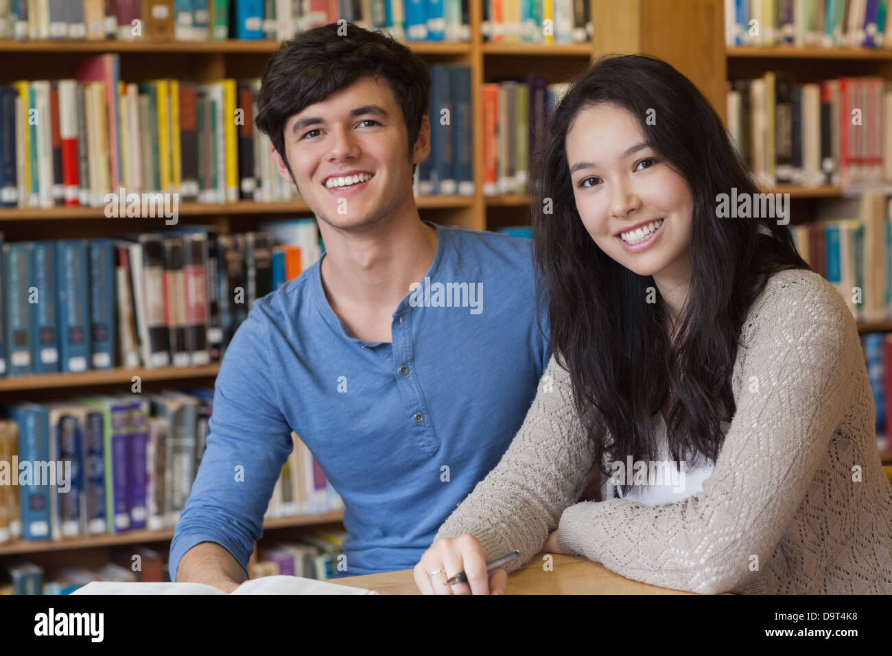 Two students in a library Stock Photo - Alamy