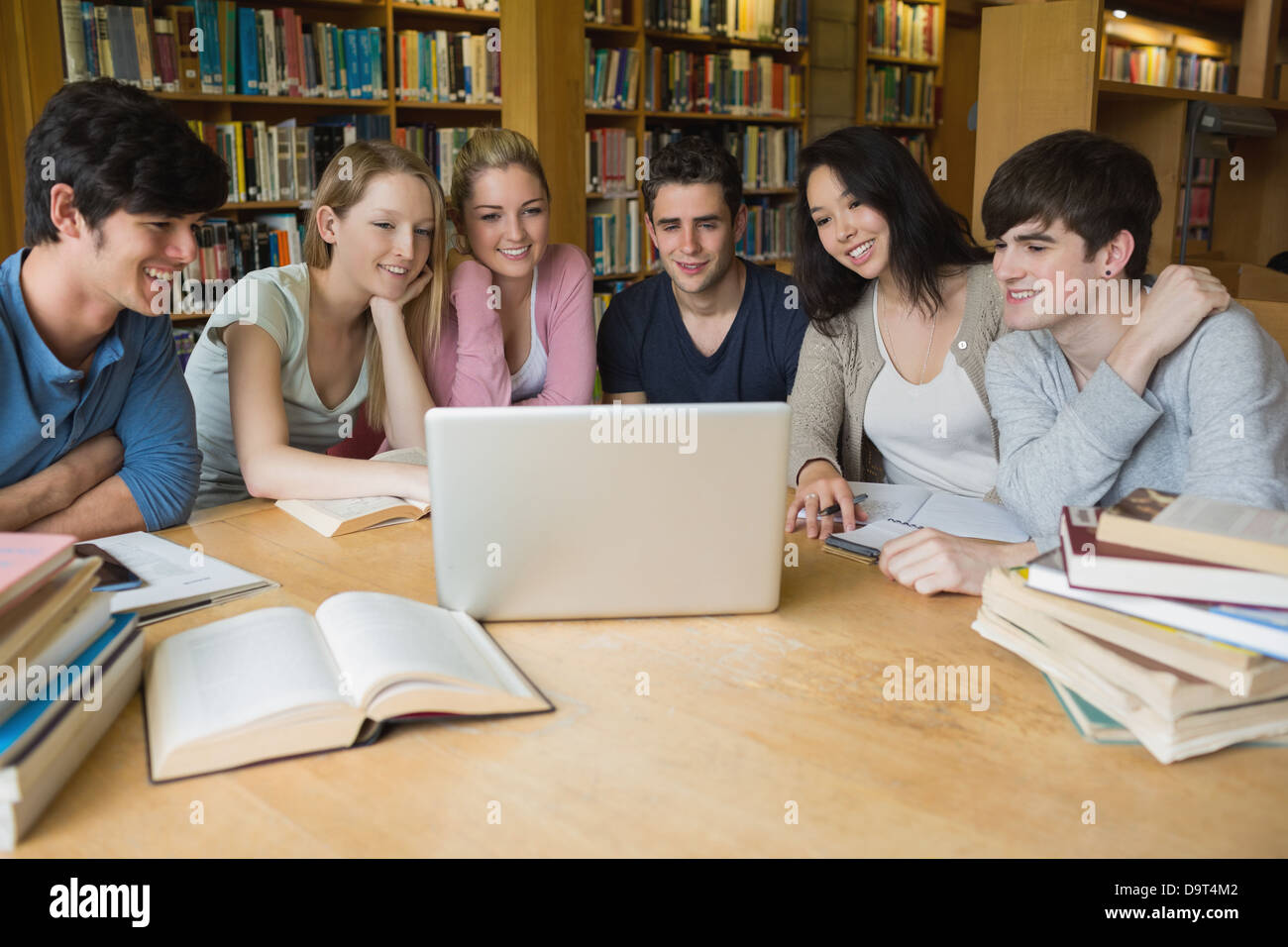 Group of students learning in a library Stock Photo - Alamy