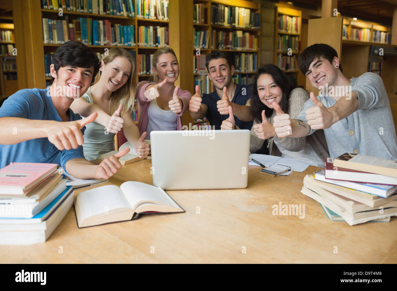 Group of students giving thumbs up Stock Photo - Alamy