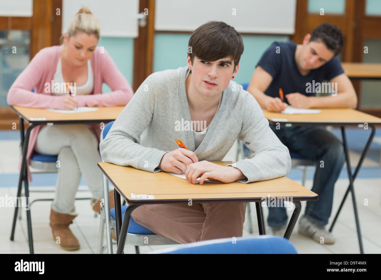 Thoughtful student writing Stock Photo - Alamy Thoughtful student writing Stock Photo - Alamy