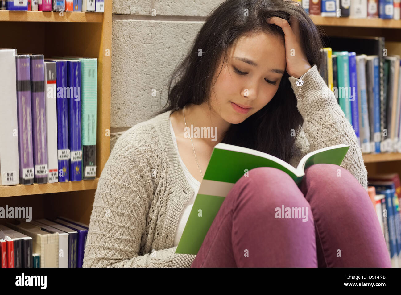 Stressed student reading a book Stock Photo - Alamy