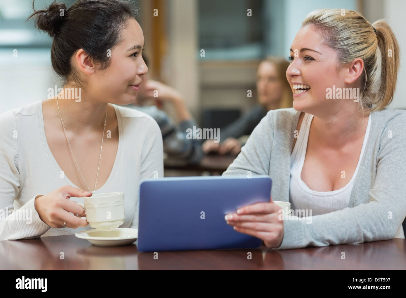 Two students chatting in a coffee shop Stock Photo - Alamy