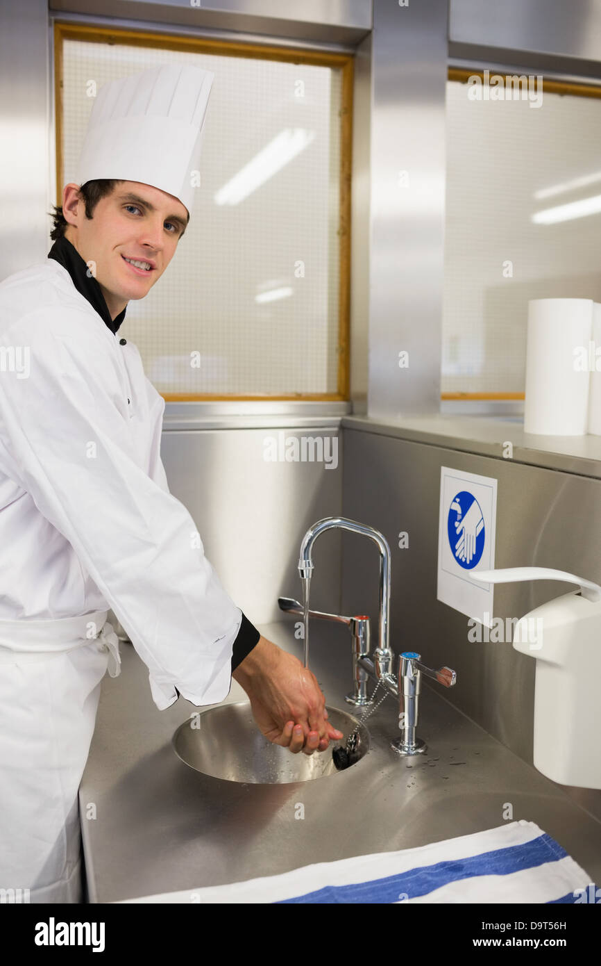 Cheerful chef washing hands Stock Photo - Alamy