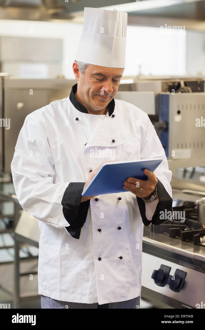 Chef using his digital tablet Stock Photo - Alamy
