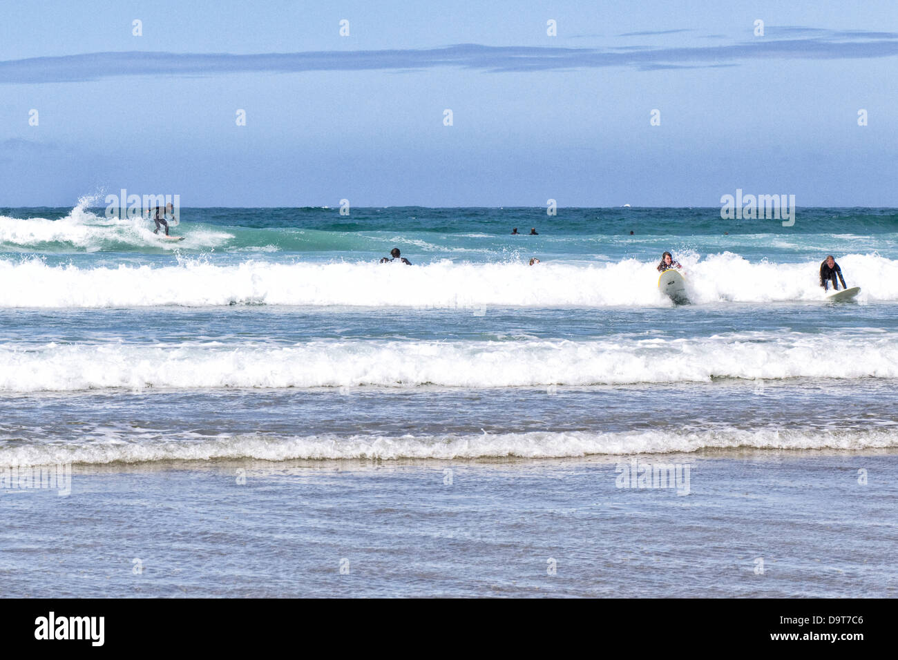 Surfers on the surf in Newquay Cornwall Stock Photo - Alamy