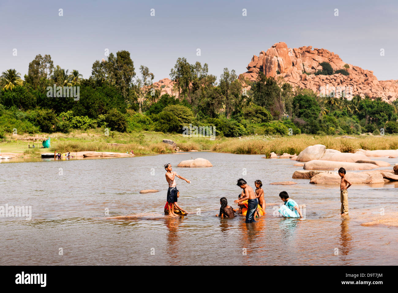 Kids playing and bathing in the Tungabhadra River in Hampi, India Stock ...