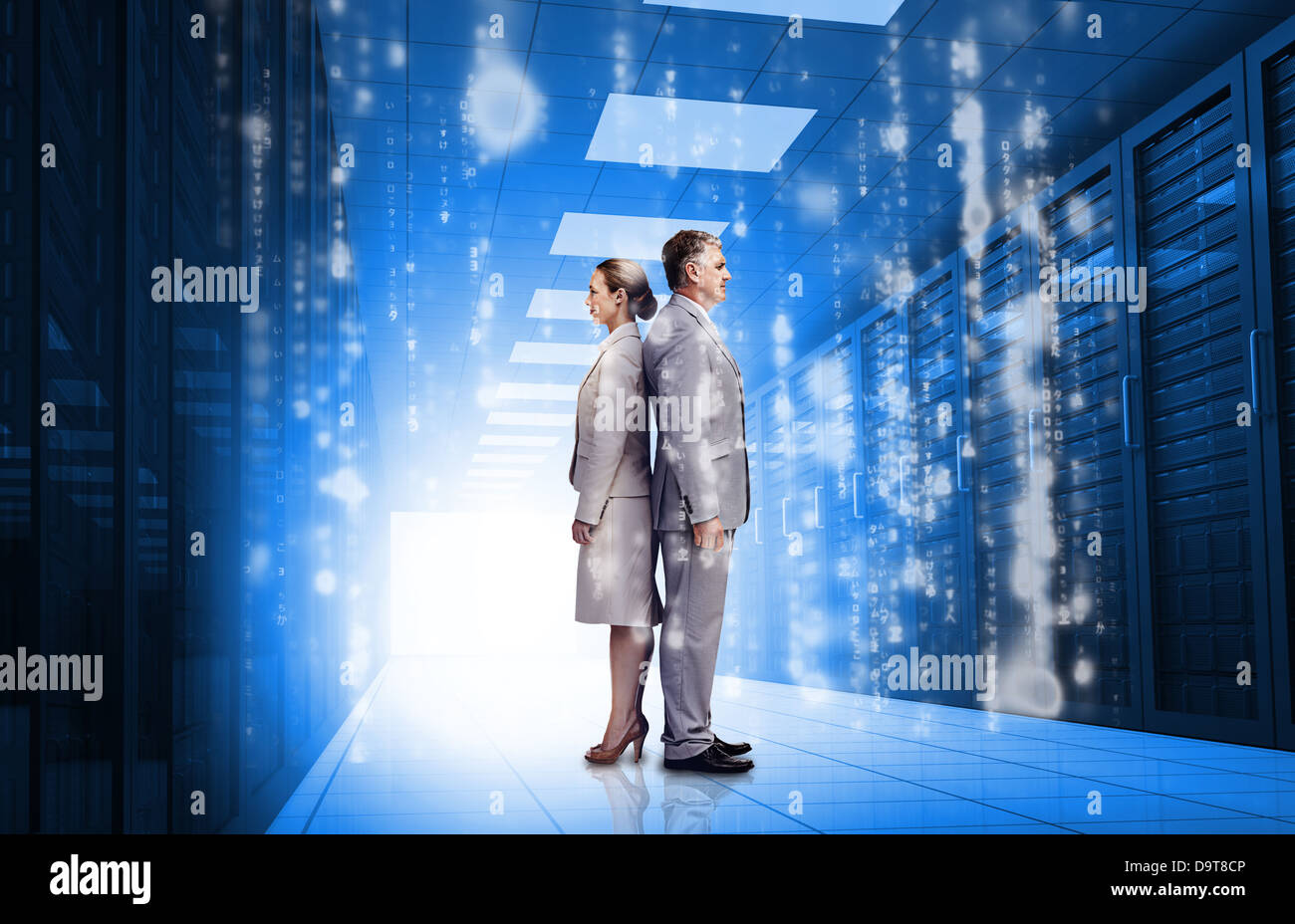 Business people standing back to back in data center Stock Photo - Alamy