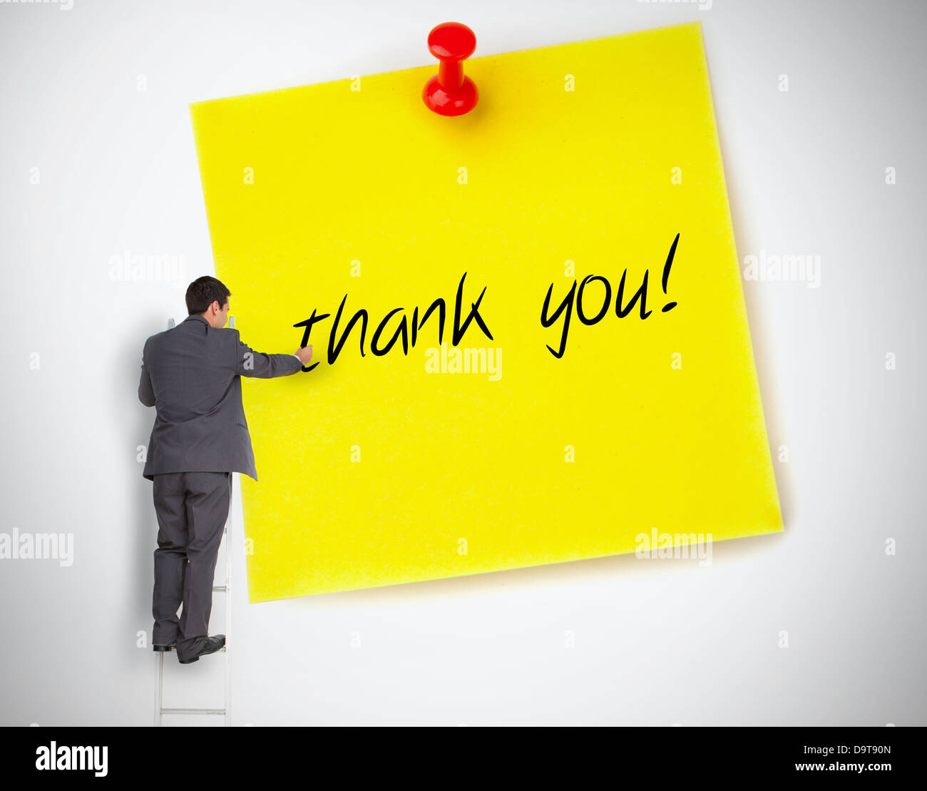 Businessman writing thank you on a giant post it Stock Photo - Alamy