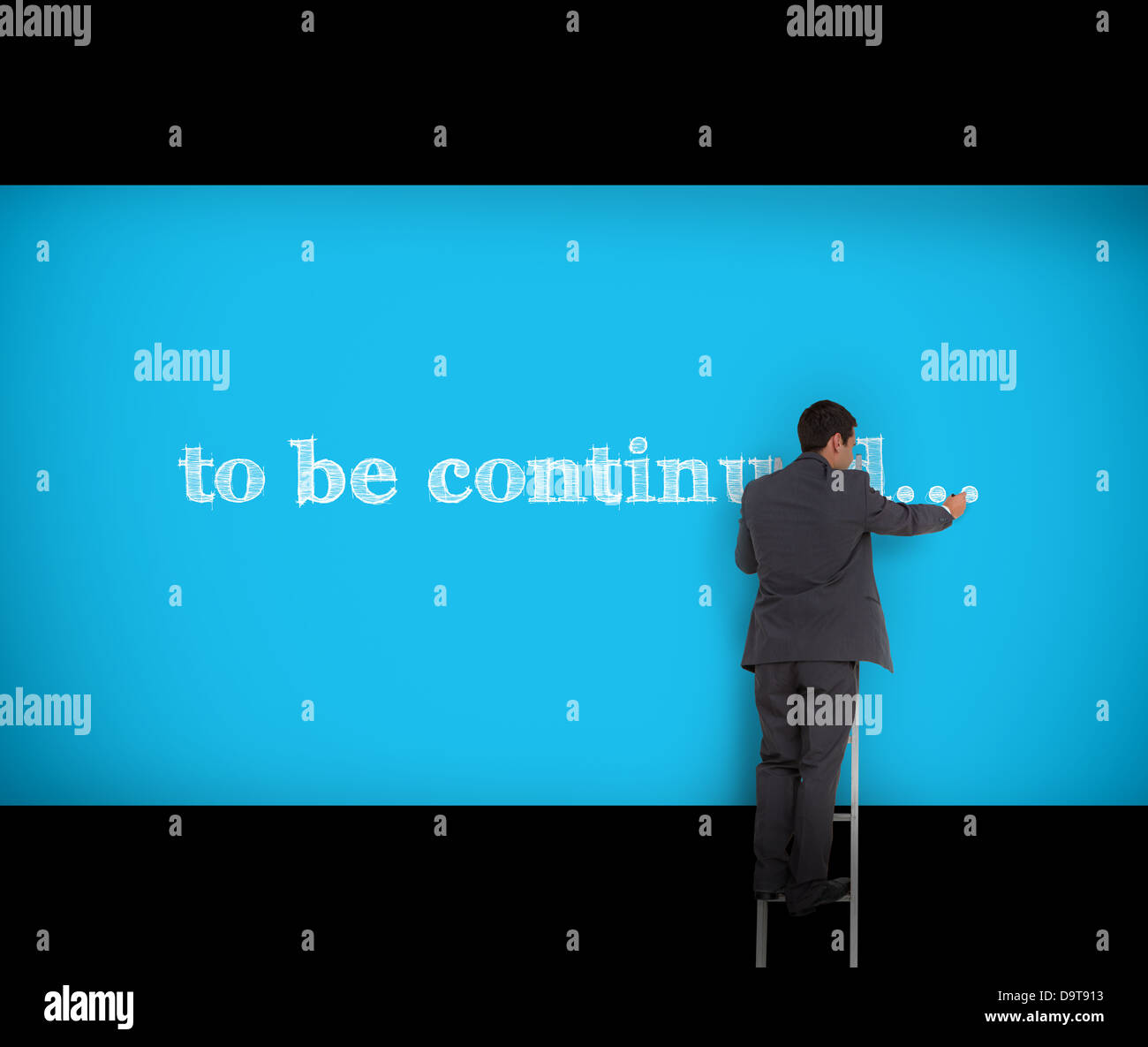 Businessman writing to be continued on a wall Stock Photo - Alamy