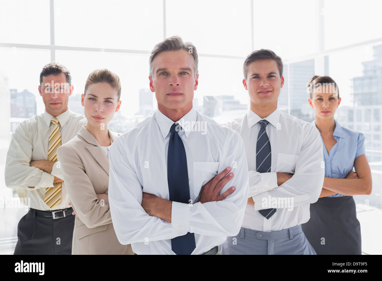 Business people with arms crossed in their office Stock Photo - Alamy