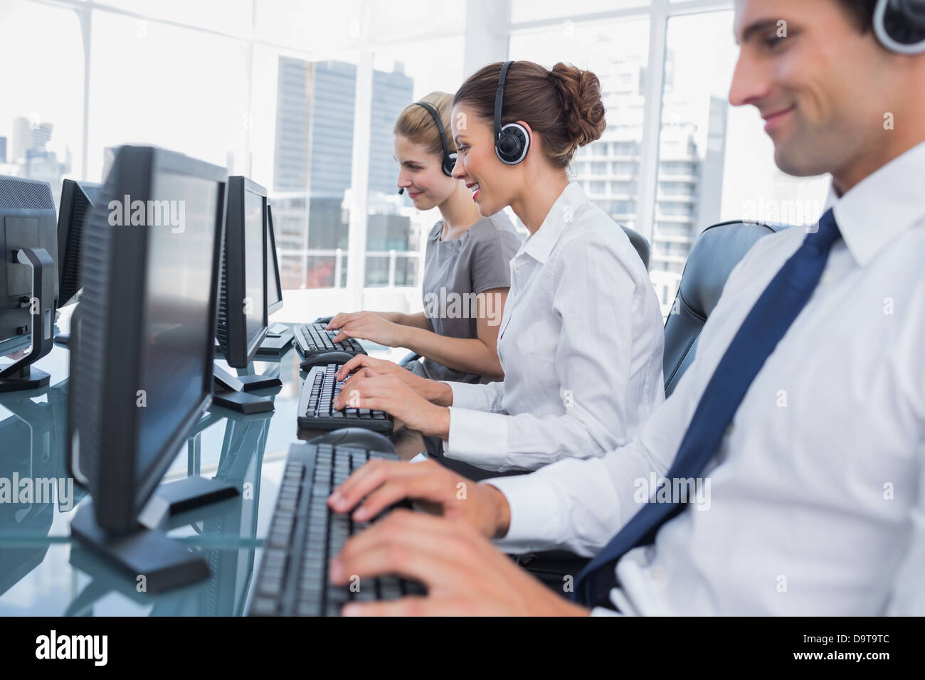 Group of call center agents working in line Stock Photo - Alamy