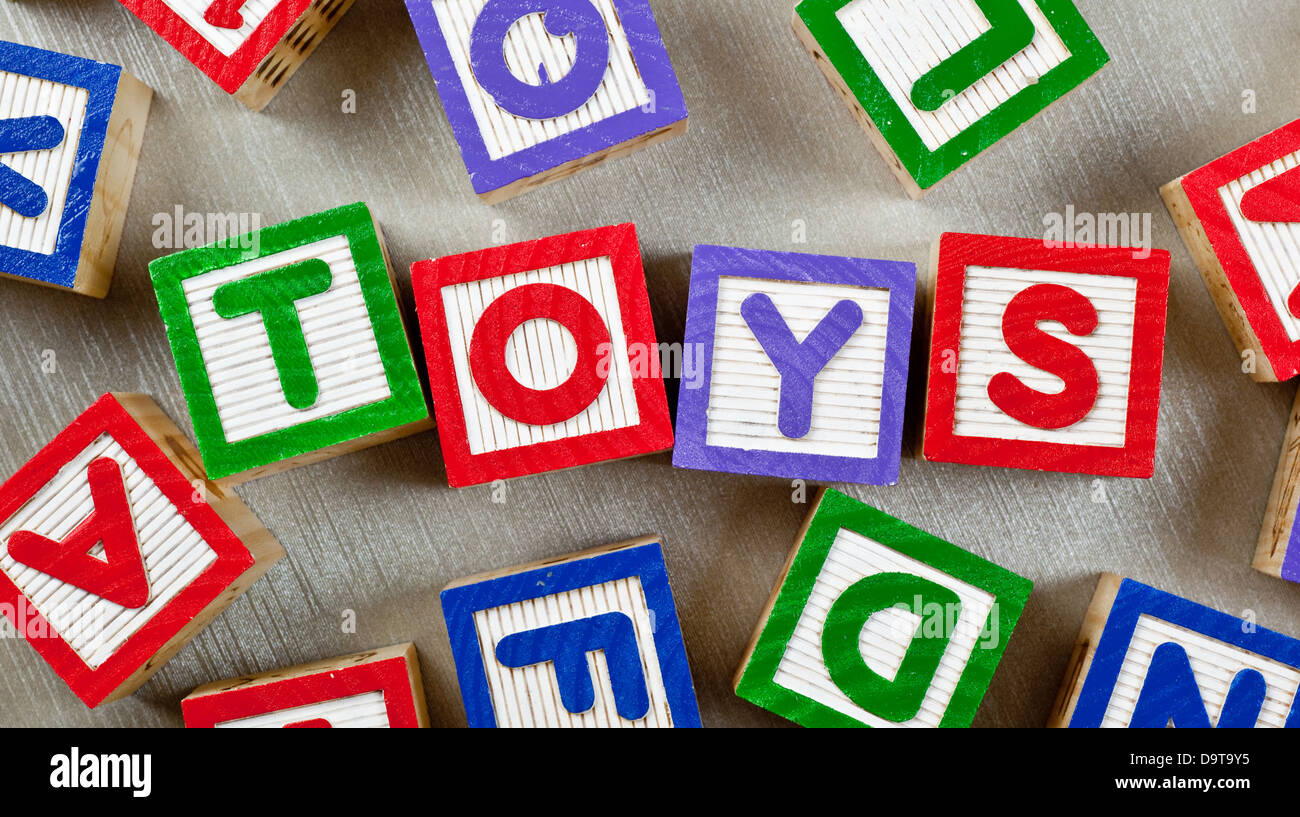Wooden blocks forming the word TOYS in the center Stock Photo - Alamy