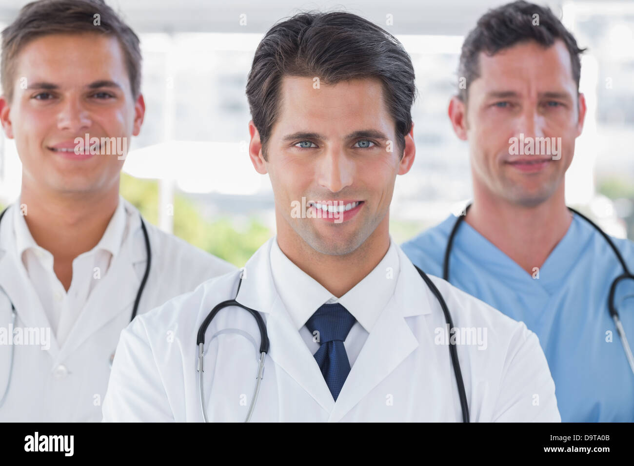 Smiling medical team standing Stock Photo - Alamy