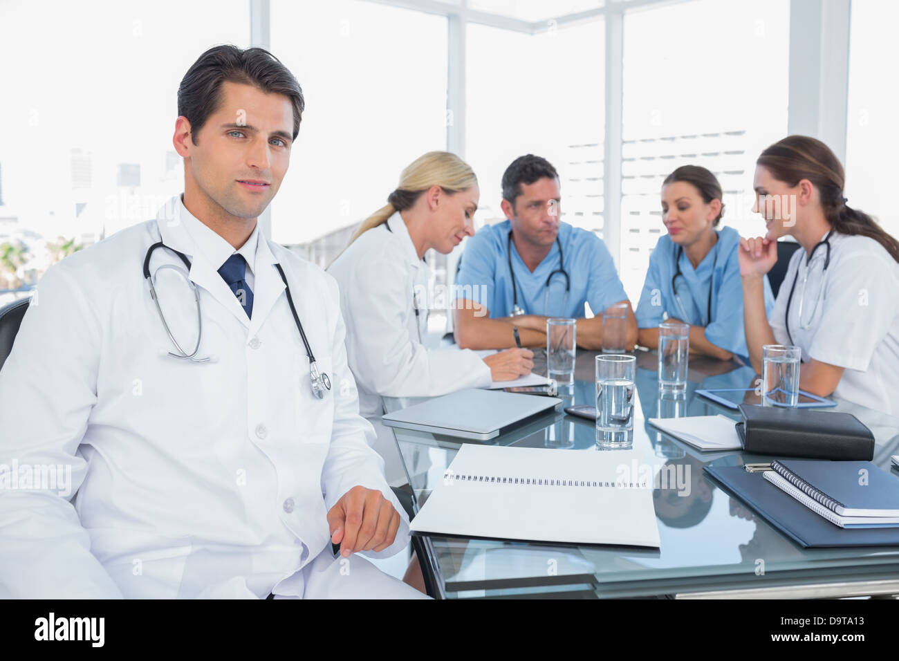 Handsome young doctor smiling camera hi-res stock photography and ...