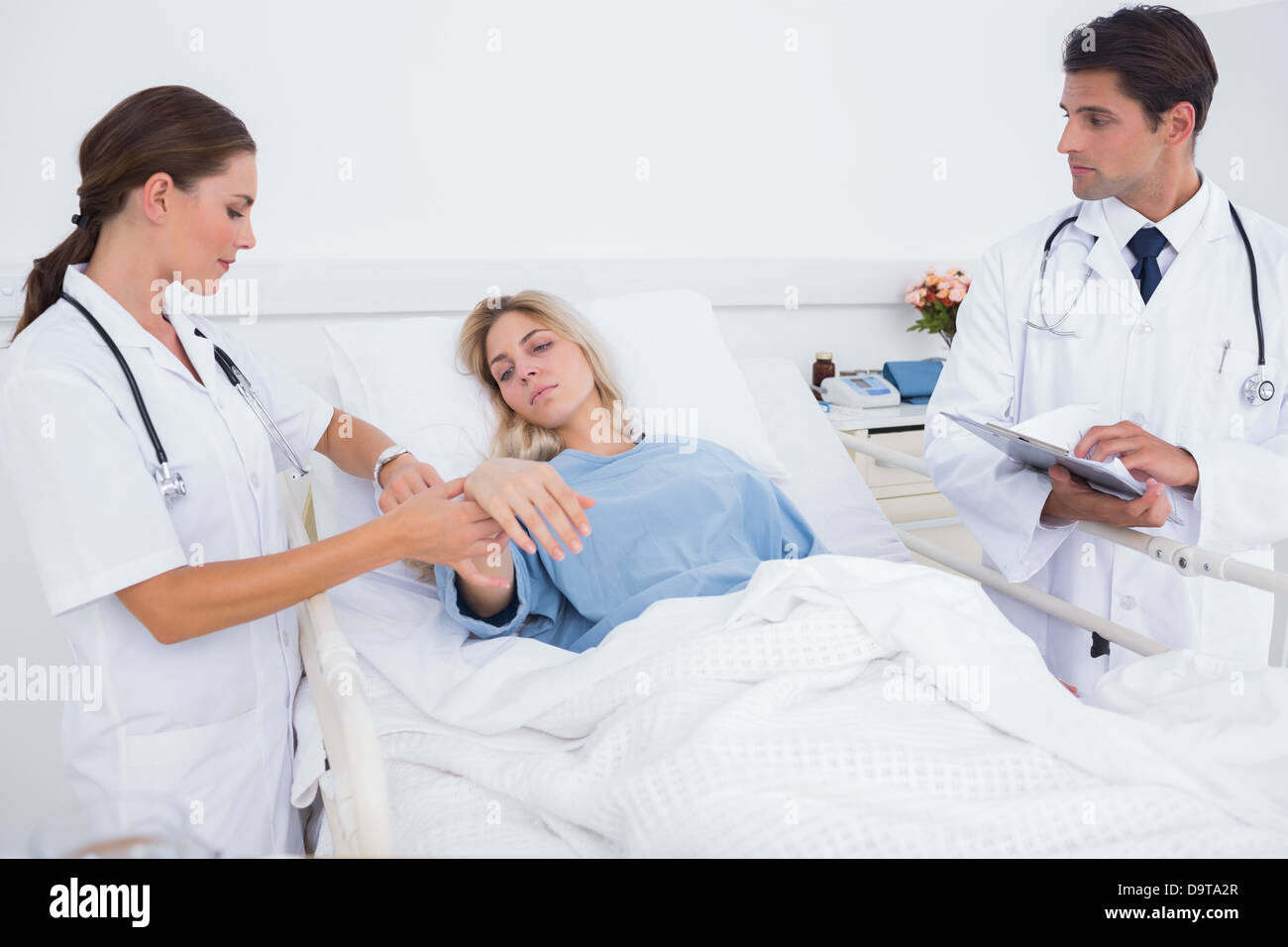 Doctor taking heartbeat of a patient Stock Photo - Alamy