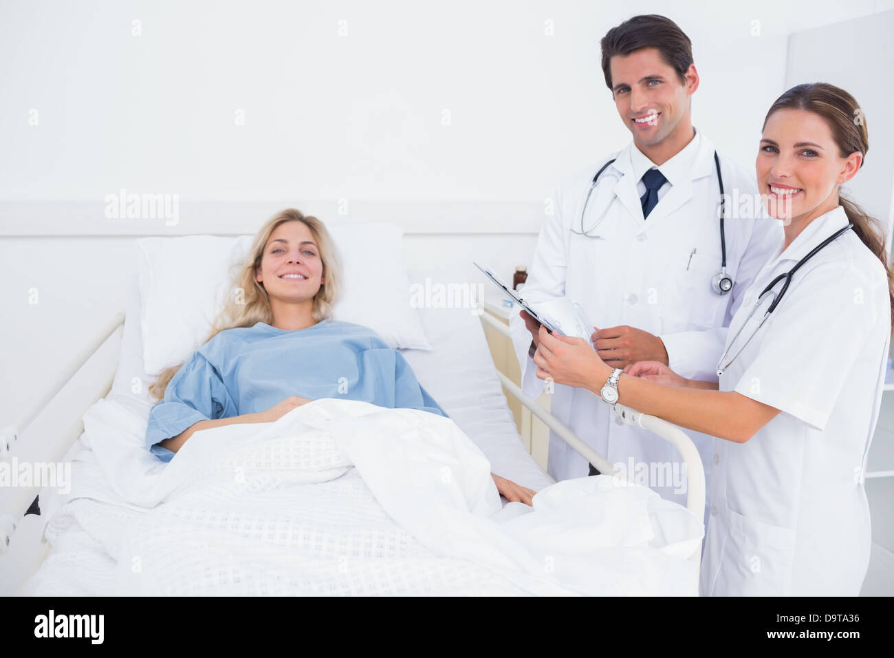 Smiling patient and doctors Stock Photo - Alamy