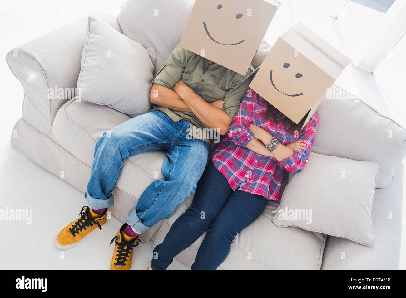 Silly employees with arms crossed wearing boxes on their heads Stock ...