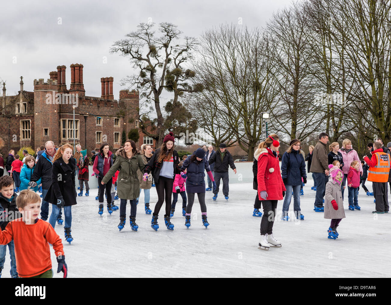 People enjoy skating on the temporary ice rink at Hampton Court Palace ...