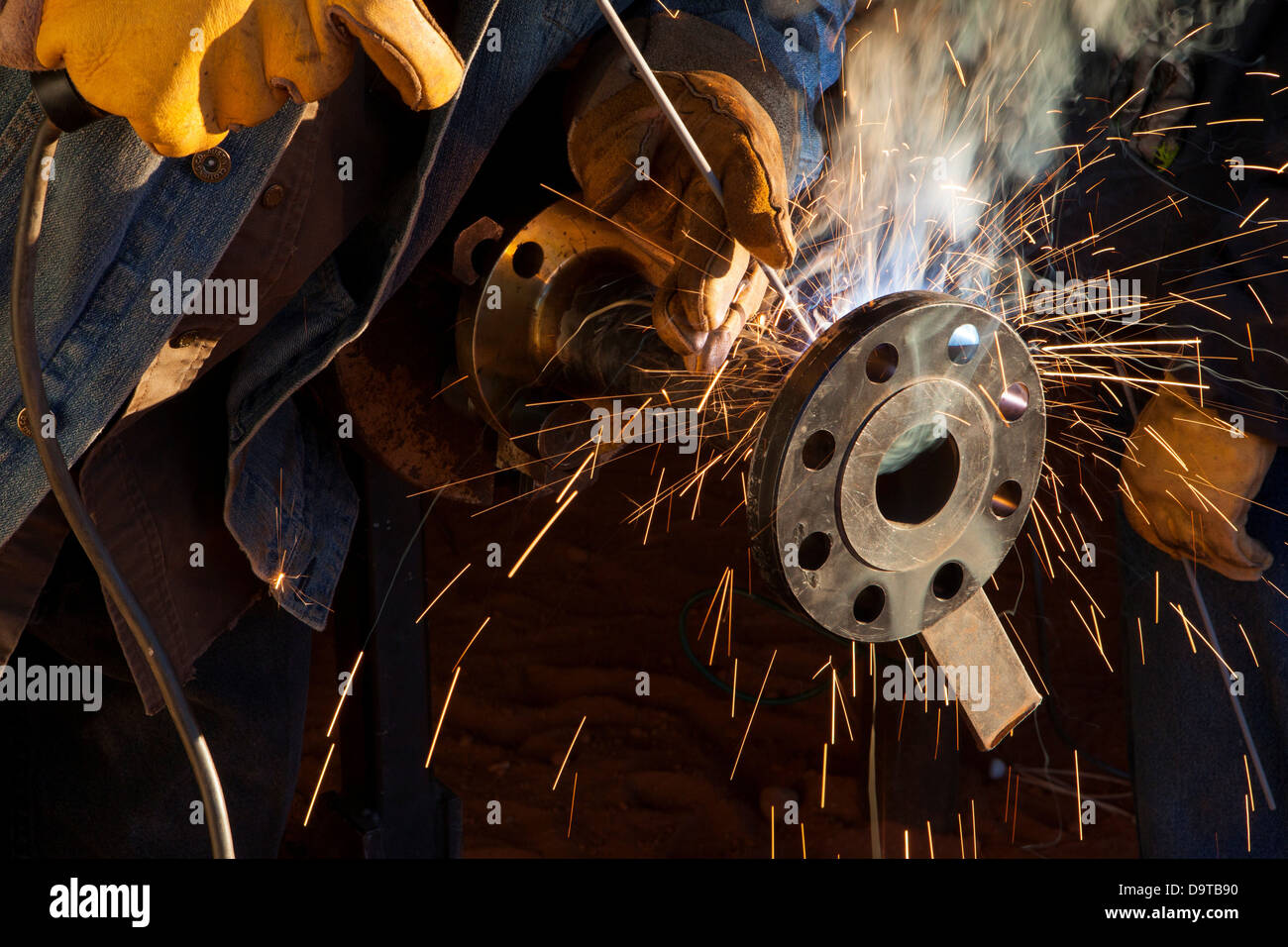 Welder working on oil pipelines in a factory Stock Photo - Alamy
