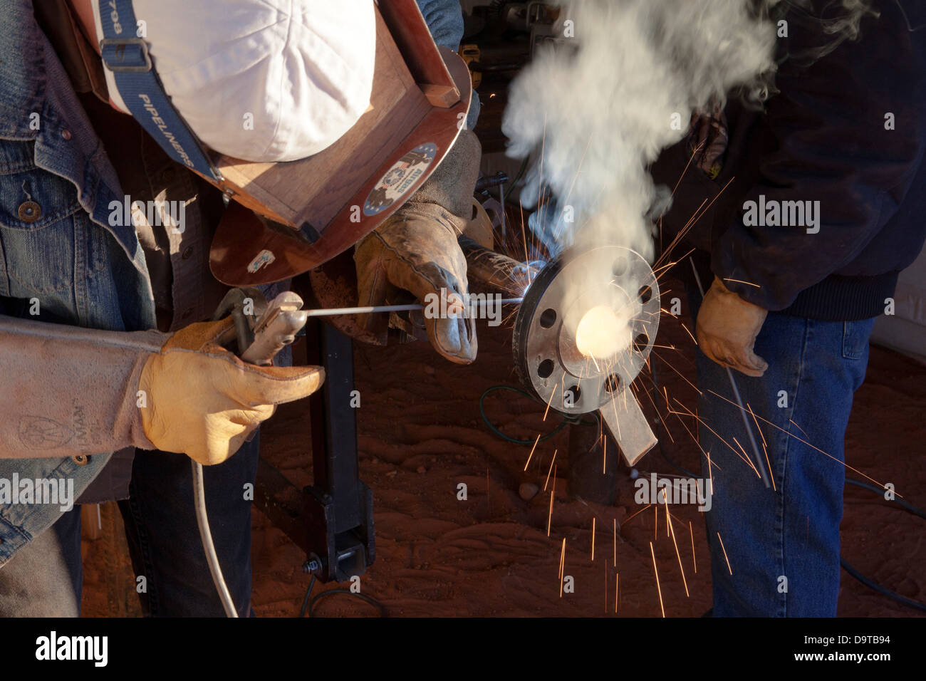 Welder working on oil pipelines in a factory Stock Photo - Alamy
