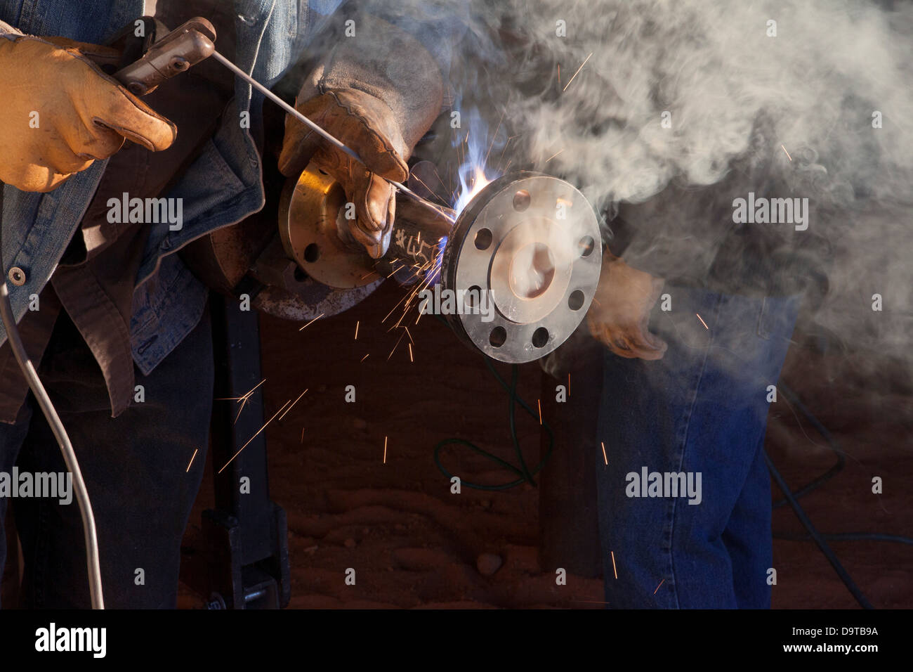 Welder working on oil pipelines in a factory Stock Photo - Alamy