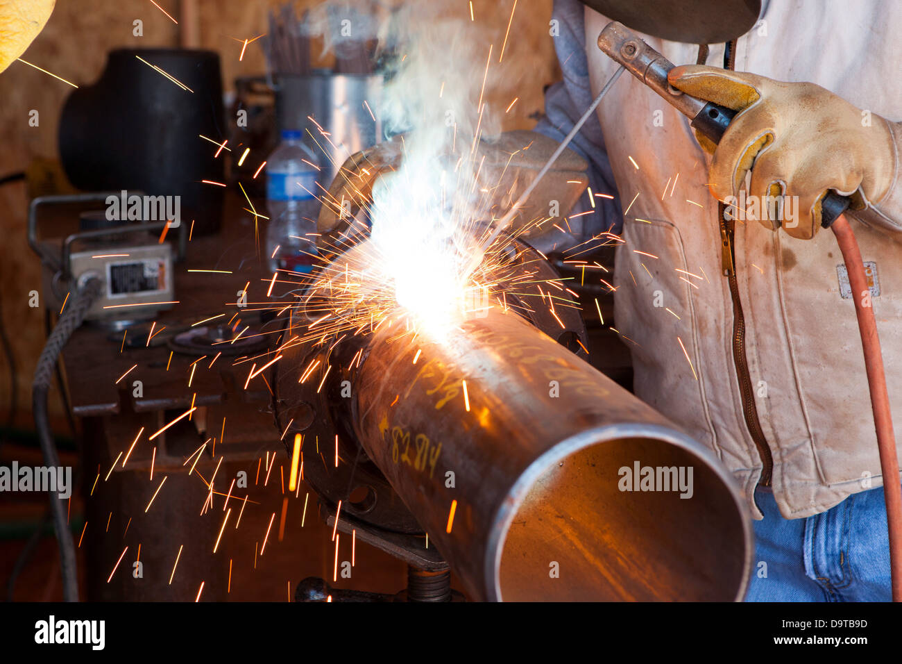 Welder working on oil pipelines in a factory Stock Photo - Alamy