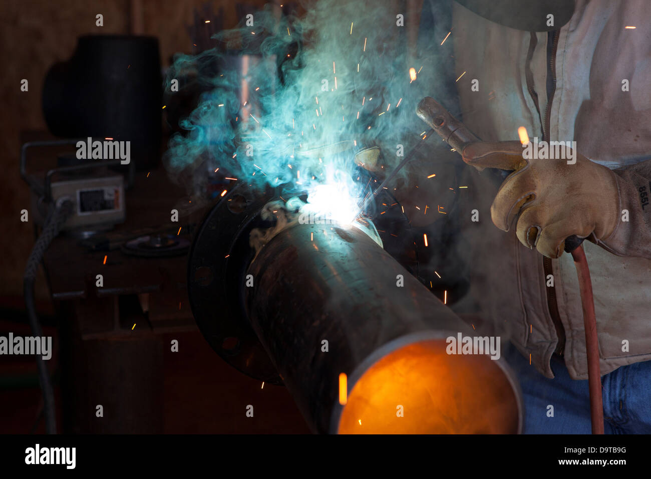 Welder working on oil pipelines in a factory Stock Photo - Alamy