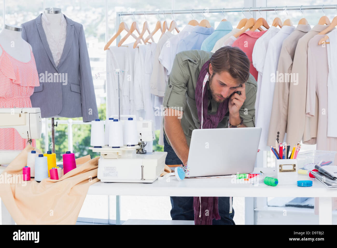 Fashion designer using laptop Stock Photo - Alamy