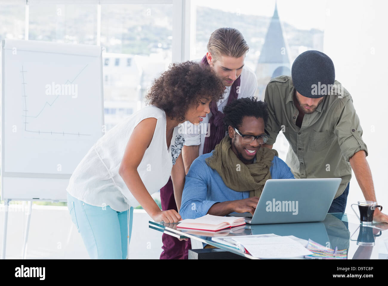 Attractive designers working in office at desk Stock Photo - Alamy