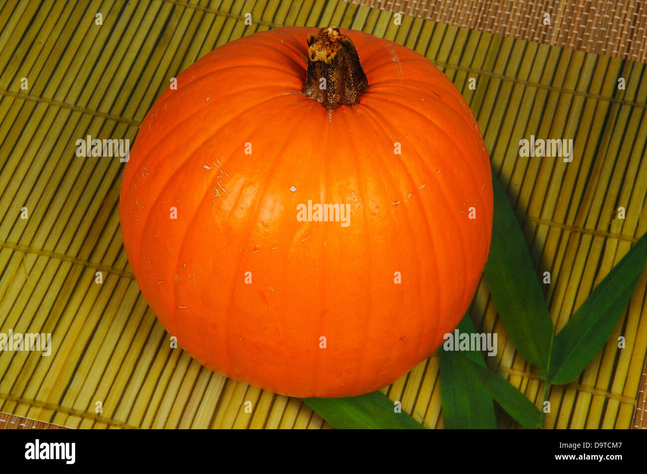 Whole pumpkin on a bamboo mat Stock Photo - Alamy