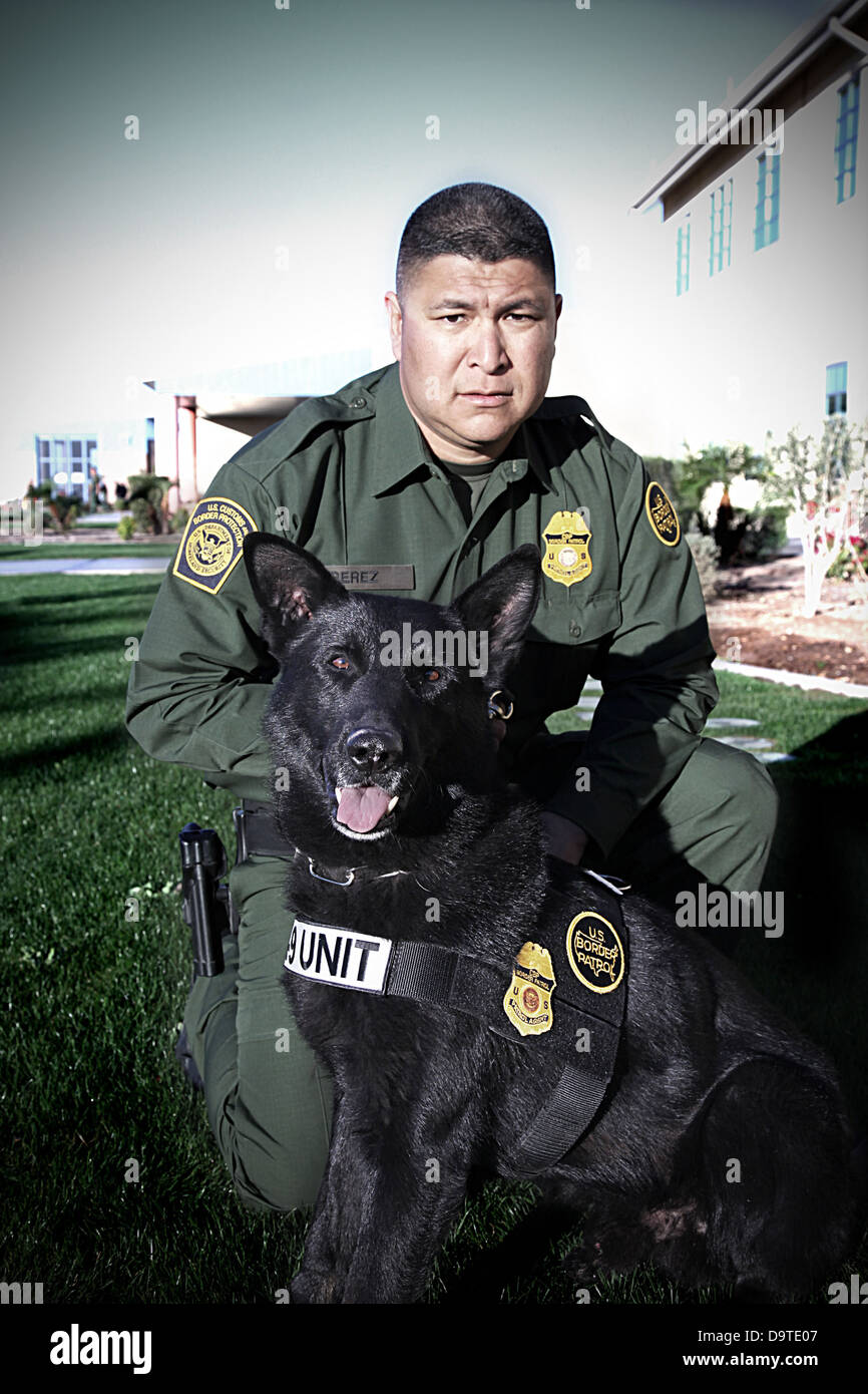 A U.S. Border Patrol agent is photographed with their canine partner ...