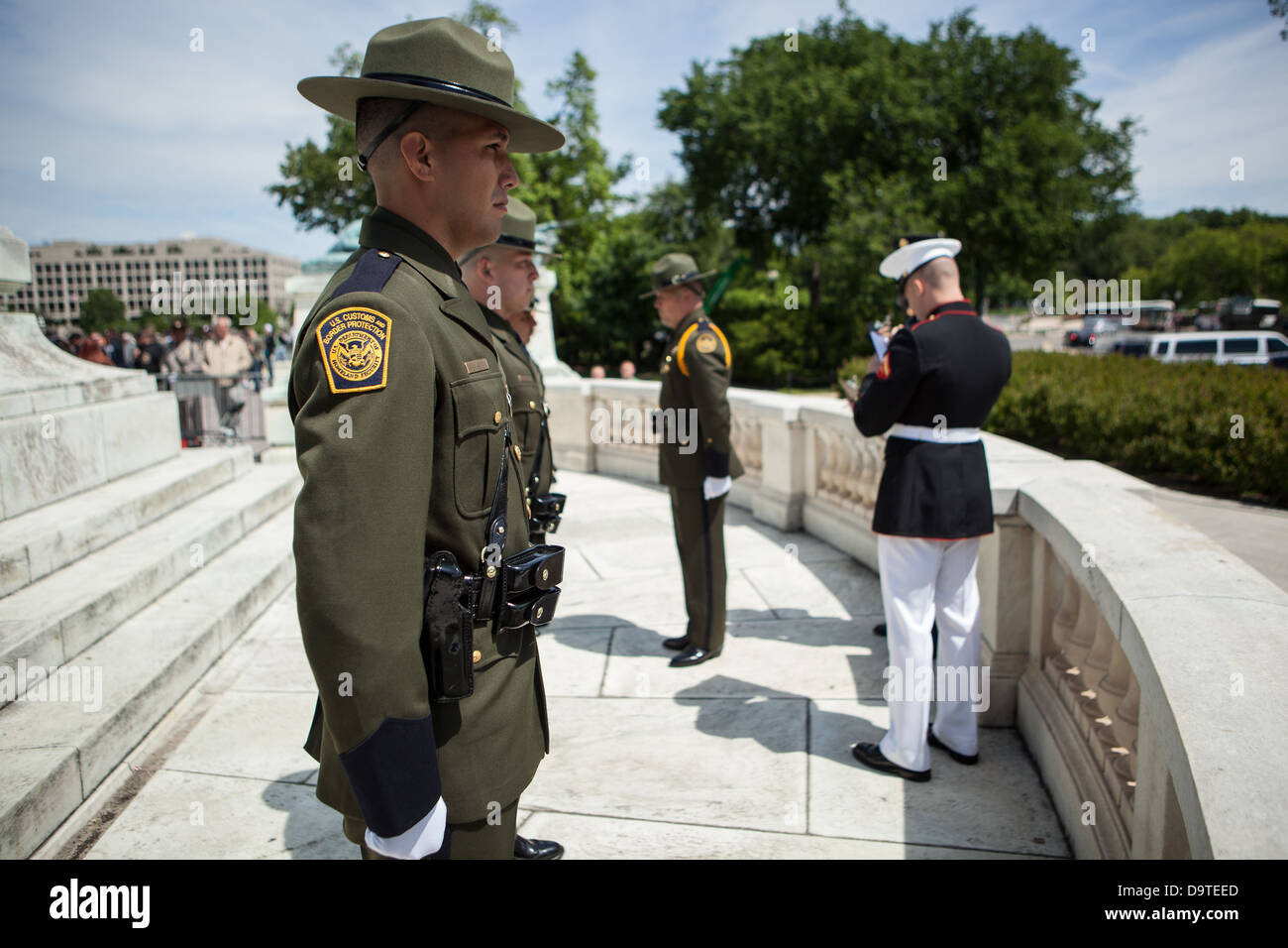 A photograph capturing the Border Patrol Drill Team performing during a ...