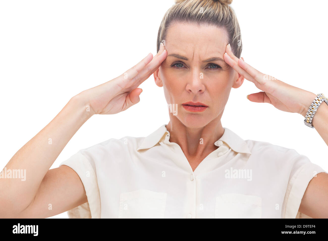 Wincing businesswoman with hand on head Stock Photo - Alamy