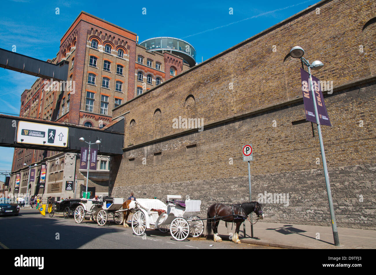 Horse drawn carriages waiting in front of Guinness Storehouse and St ...